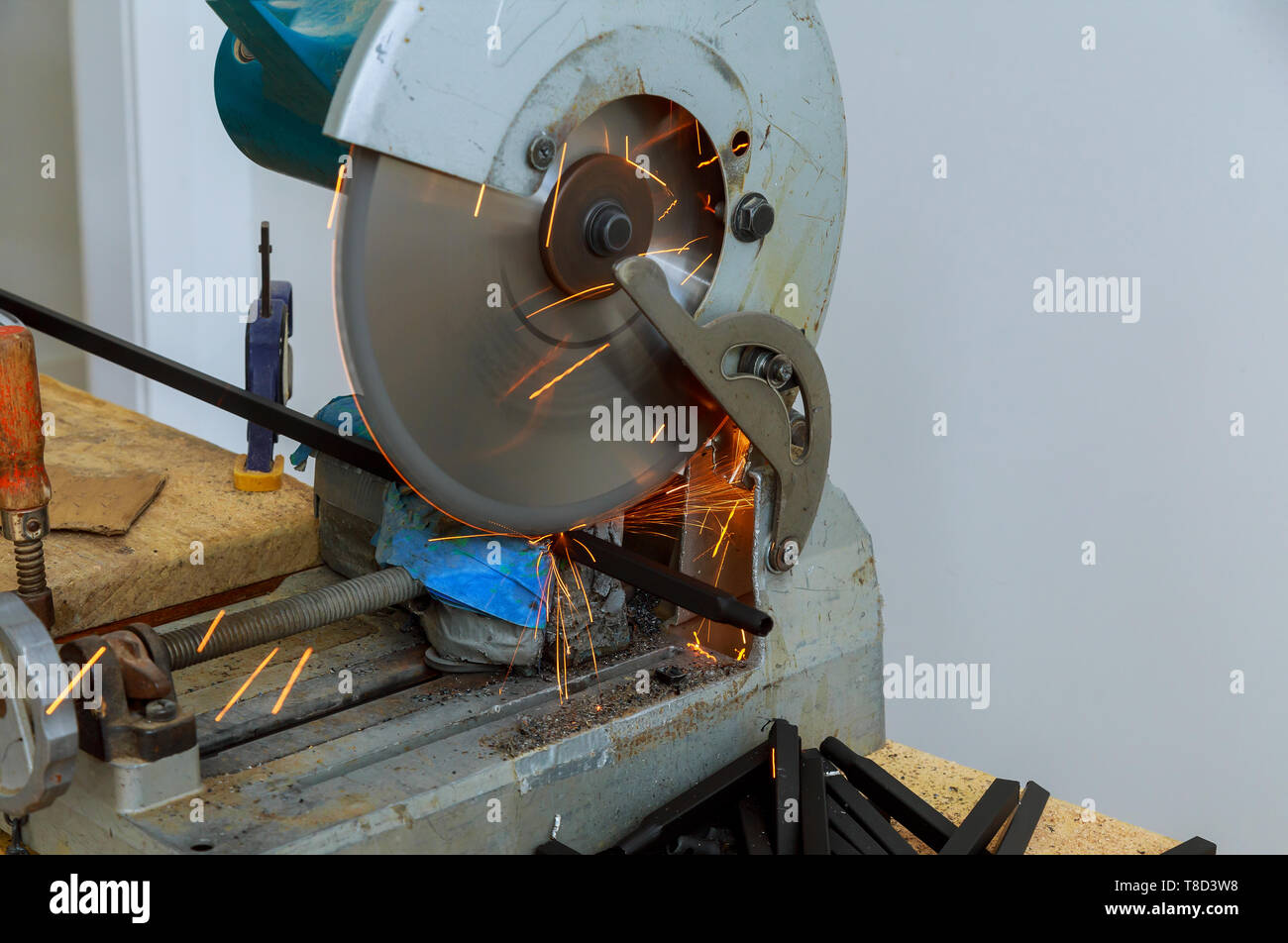 Circular electro saw cutting iron steel railings fence by with sparks ...