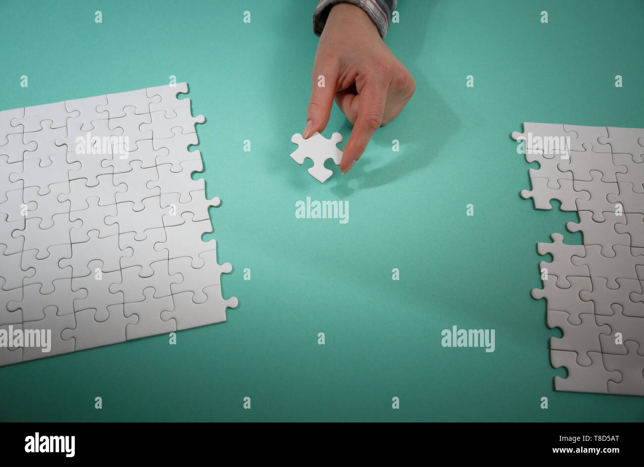 Hands assembling jigsaw puzzle, to find common solution concept Stock ...