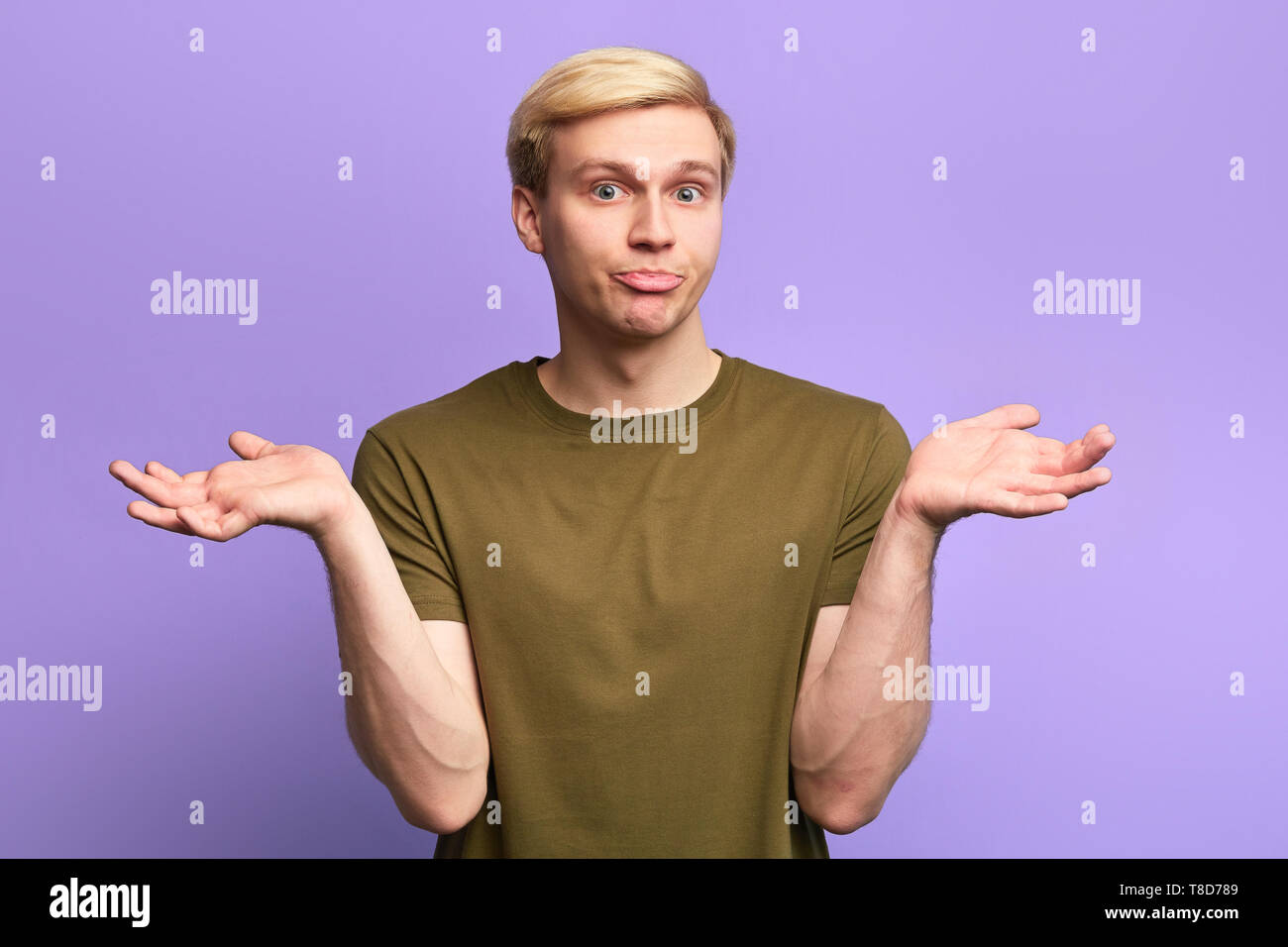 Handsome young man shrugging shoulders hi-res stock photography and ...
