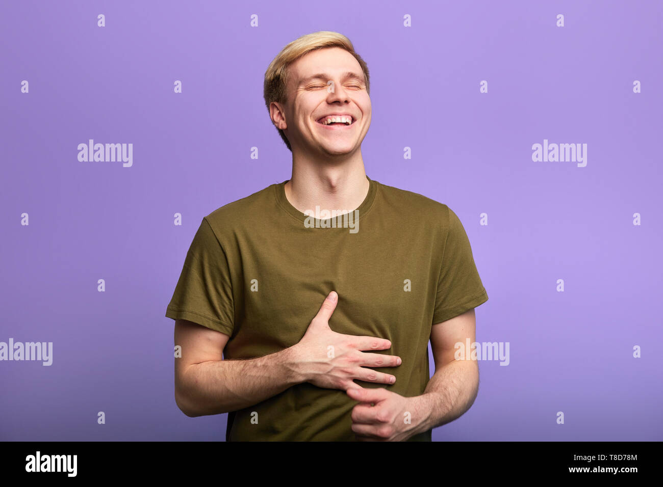 happy positive man touches stomach, can t stop laughing, being in good ...