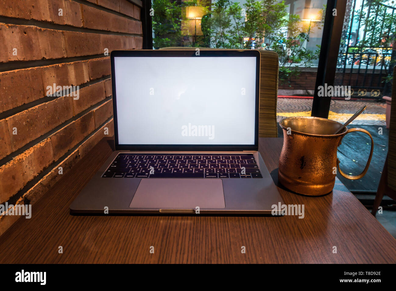 Conceptual workspace, Laptop computer with blank white screen on table ...