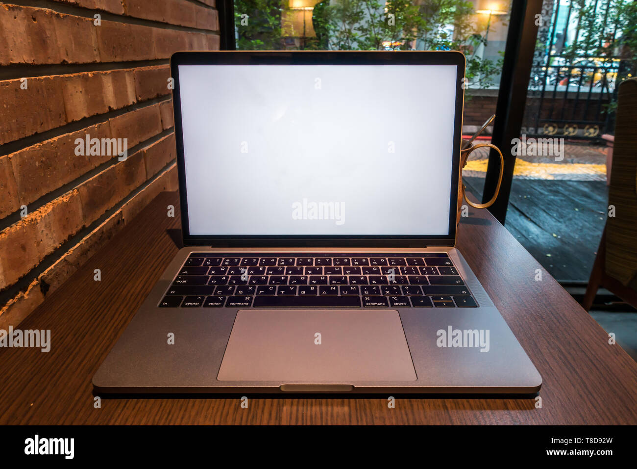 Conceptual workspace, Laptop computer with blank white screen on table ...