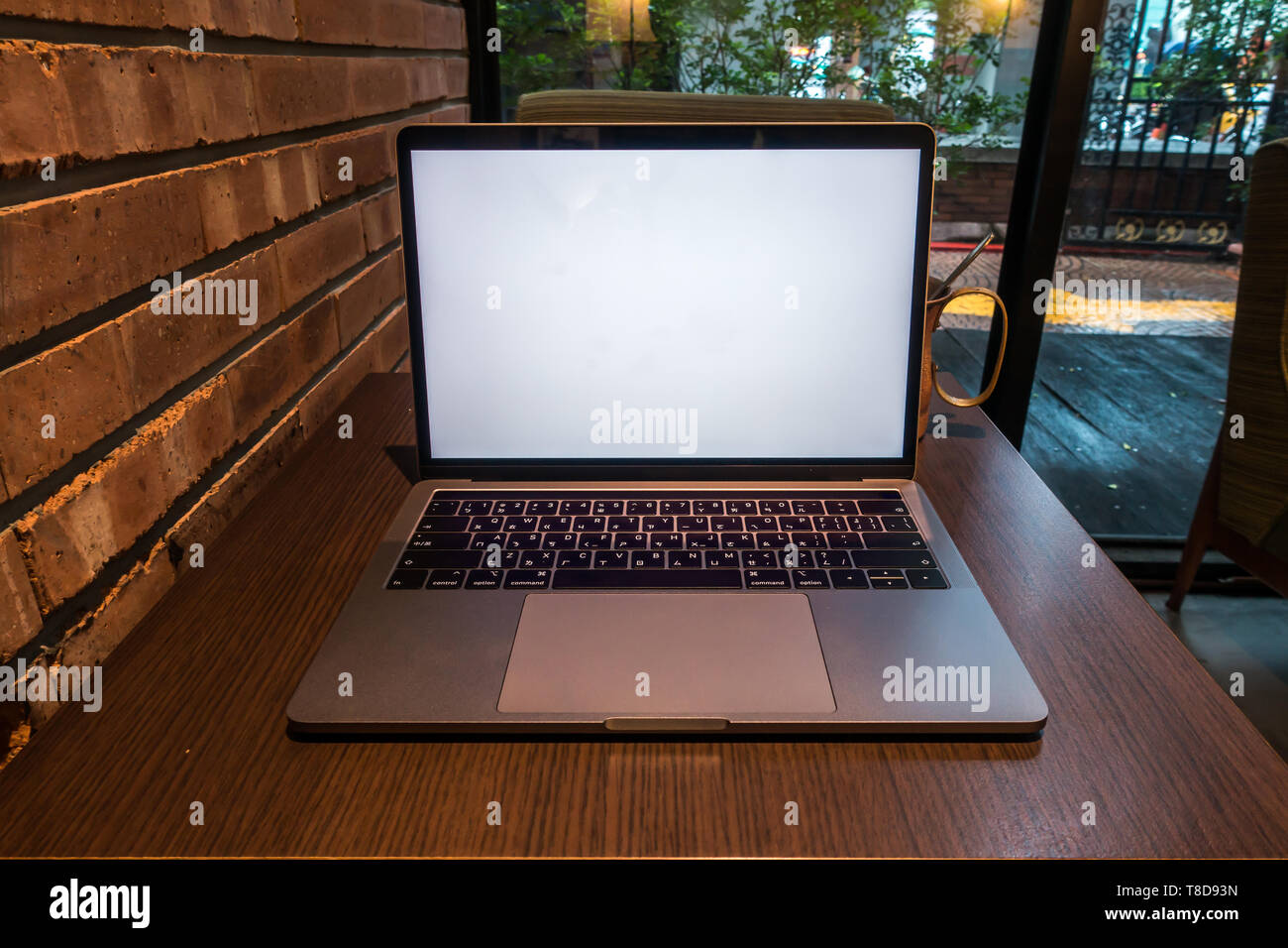 Conceptual workspace, Laptop computer with blank white screen on table ...