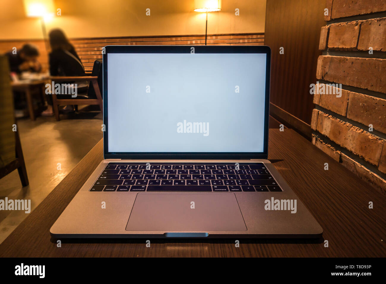 Conceptual workspace, Laptop computer with blank white screen on table ...