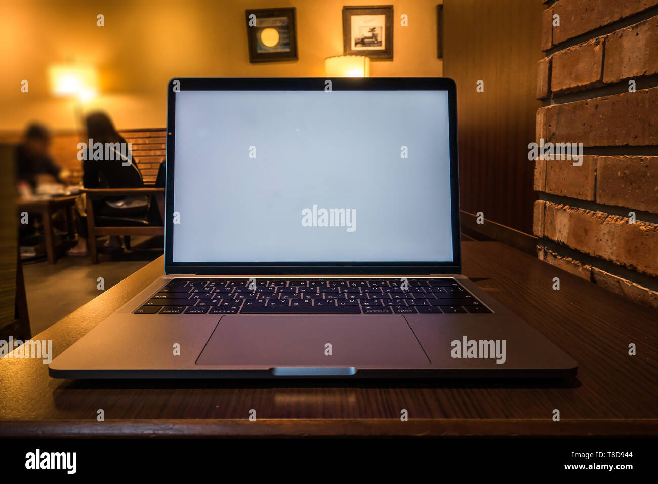 Conceptual workspace, Laptop computer with blank white screen on table ...