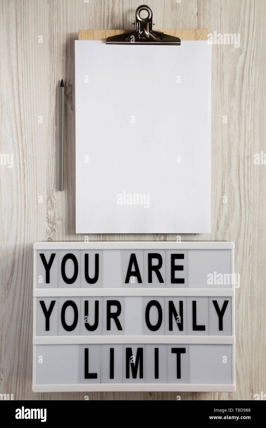 'You are your only limit' words on a modern board, clipboard with blank ...