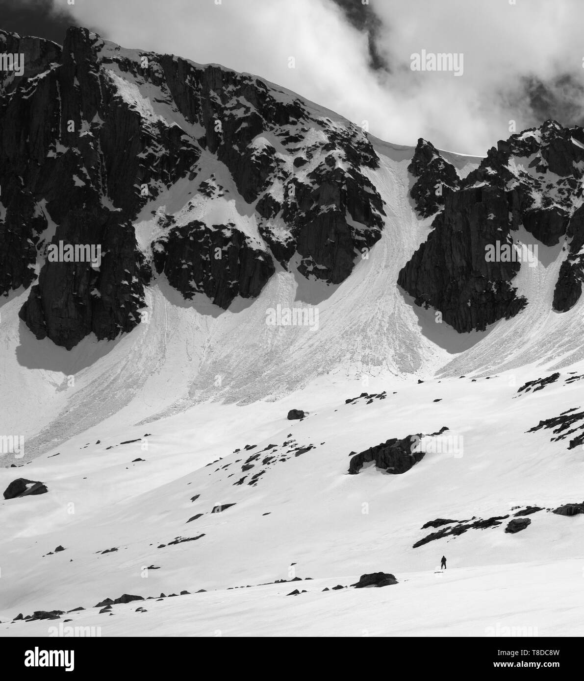 High mountains with snow cornice and avalanche tracks, snowy plateau ...