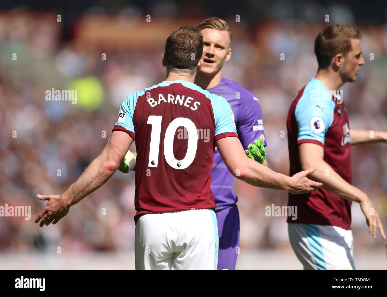 Burnley's Ashley Barnes and Arsenal goalkeeper Bernd Leno confront each ...