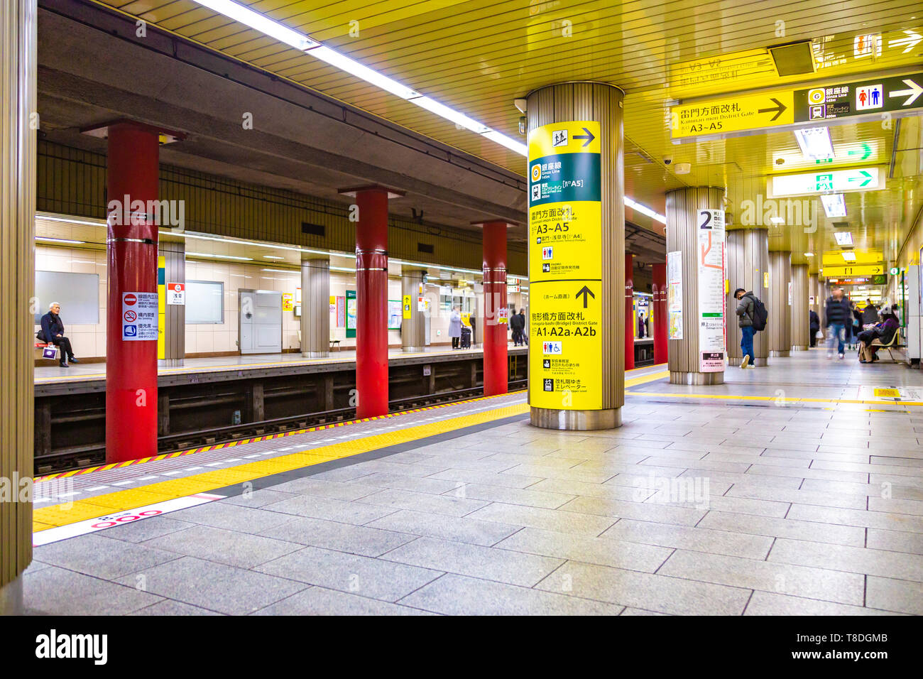 Tokyo, Japan - 24 April 2019 - Commuters wait for the subway train at a ...