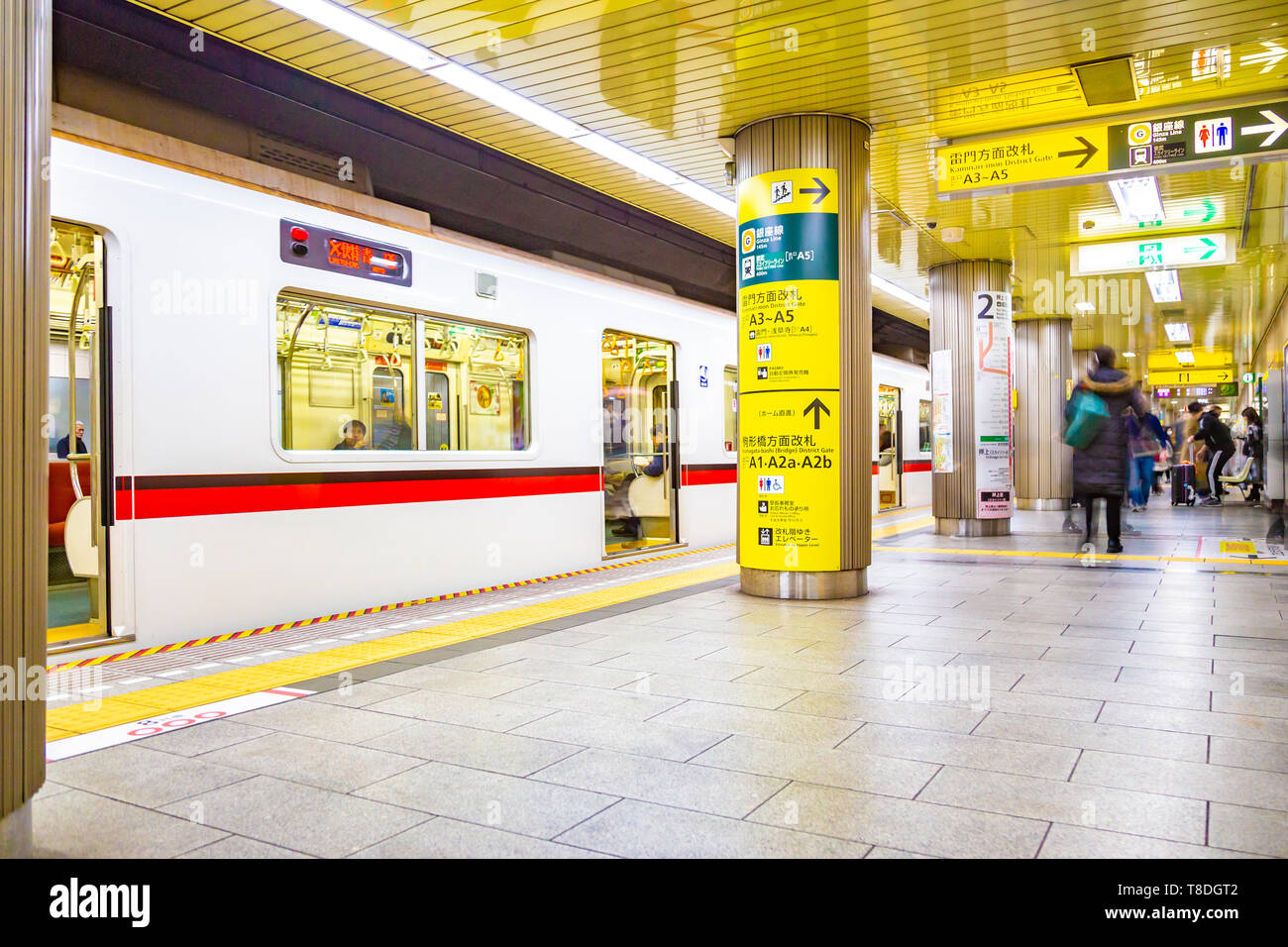 Tokyo, Japan - 24 April 2019 - Commuters wait for the subway train at a ...