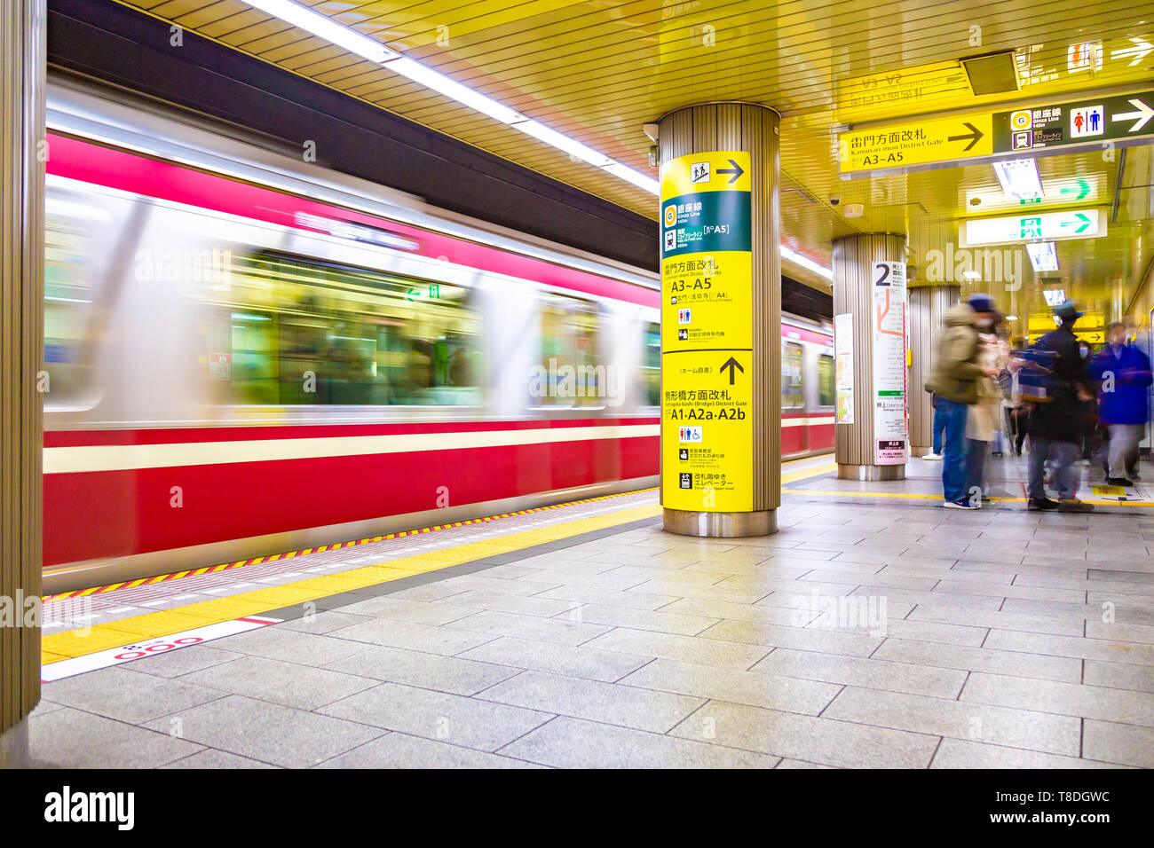 Tokyo, Japan - 24 April 2019 - Commuters wait for the subway train at a ...