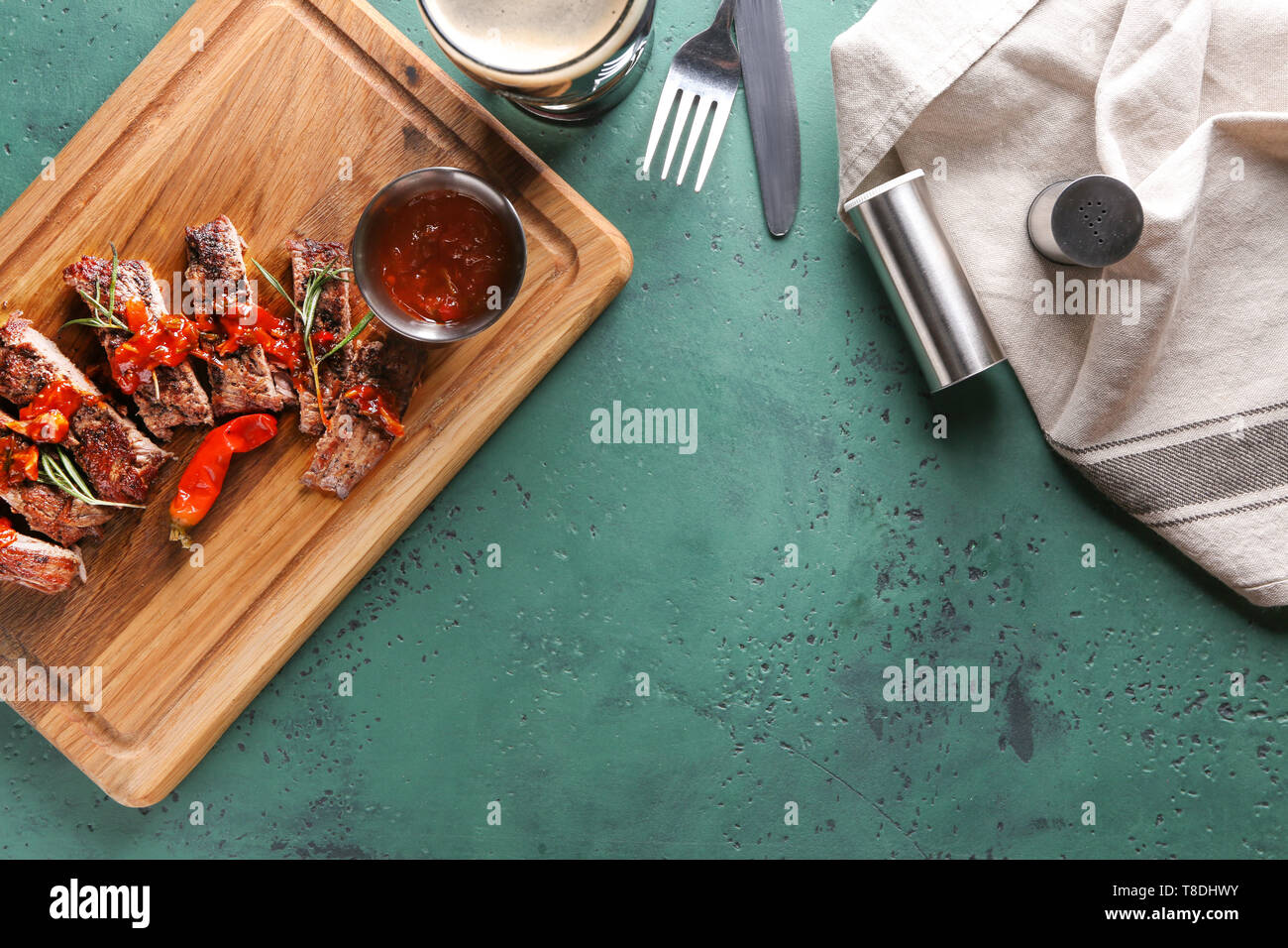 Cut grilled steak with sauce on color table Stock Photo - Alamy