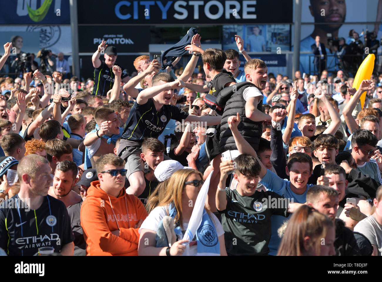Manchester City fans celebrate at the Etihad Stadium, Manchester Stock ...