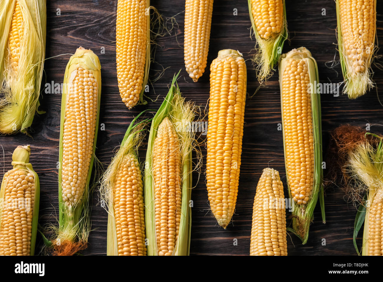 Fresh corn cobs on wooden background, flat lay Stock Photo - Alamy