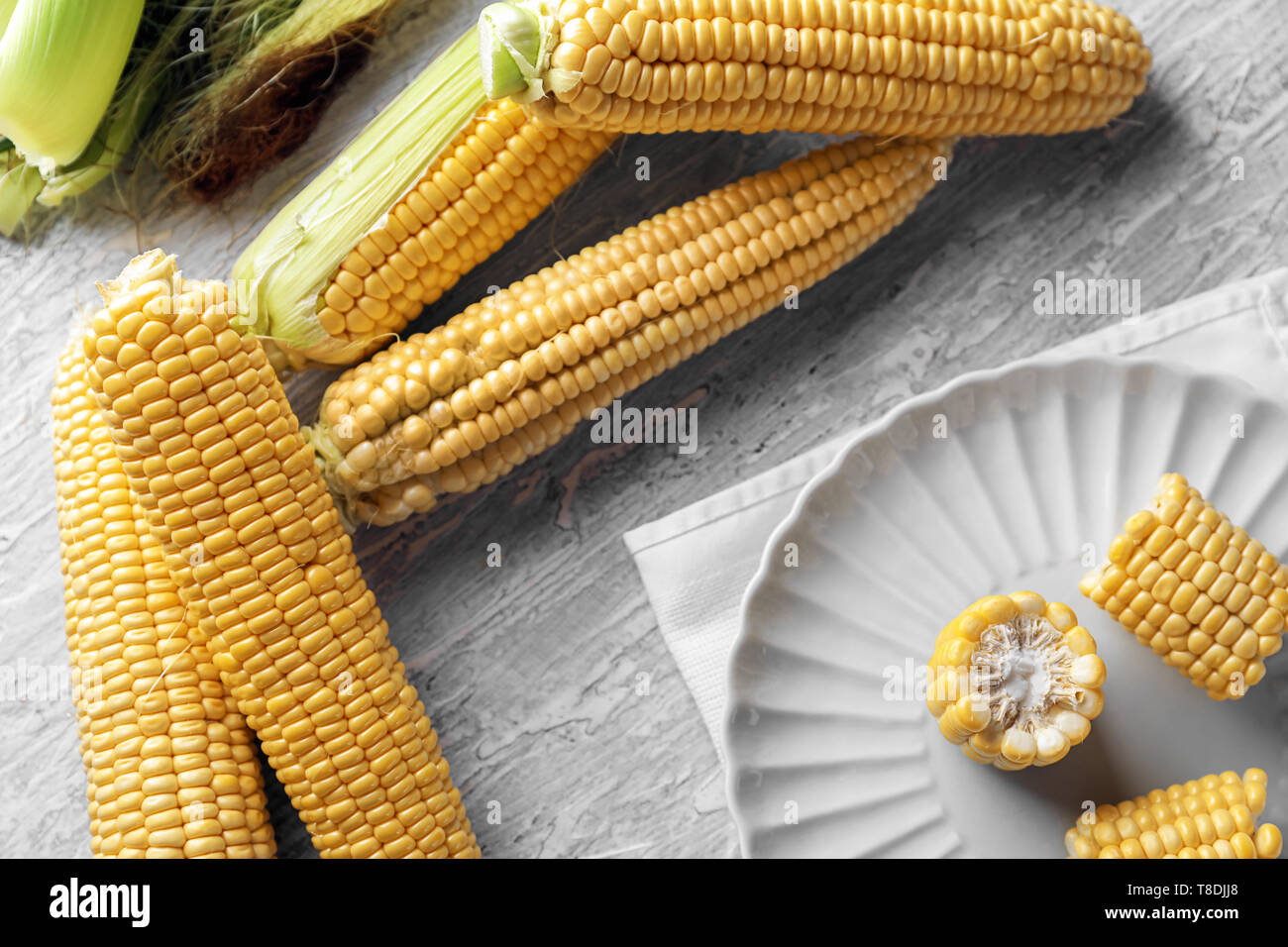 Composition with fresh corn cobs on table Stock Photo - Alamy