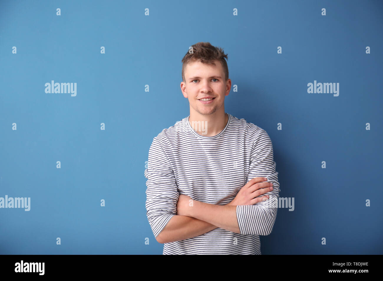 Portrait of handsome young man on color background Stock Photo - Alamy