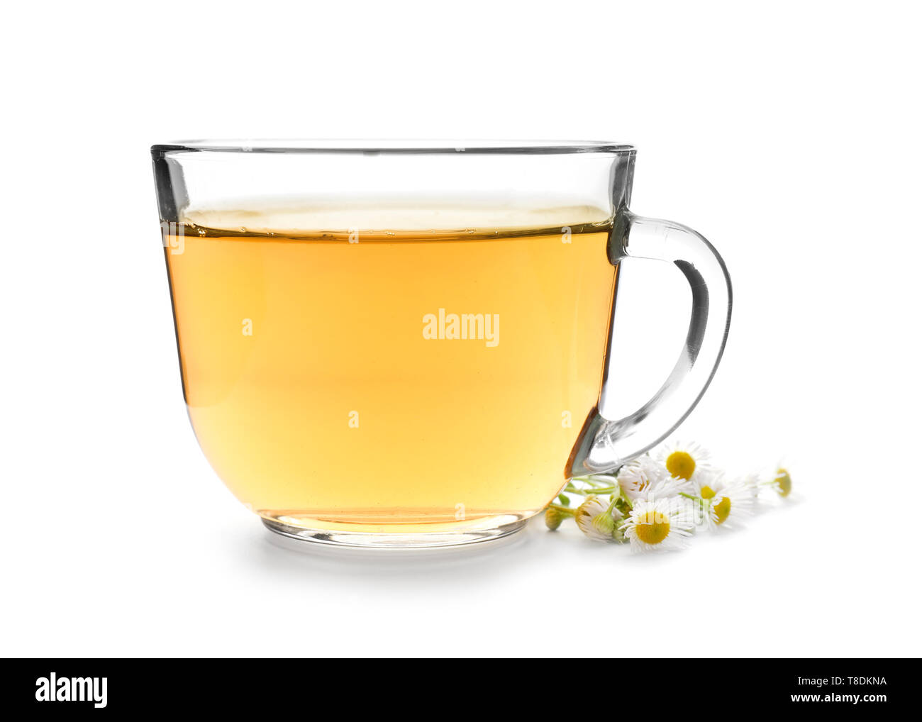 Glass cup of camomile tea on white background Stock Photo - Alamy
