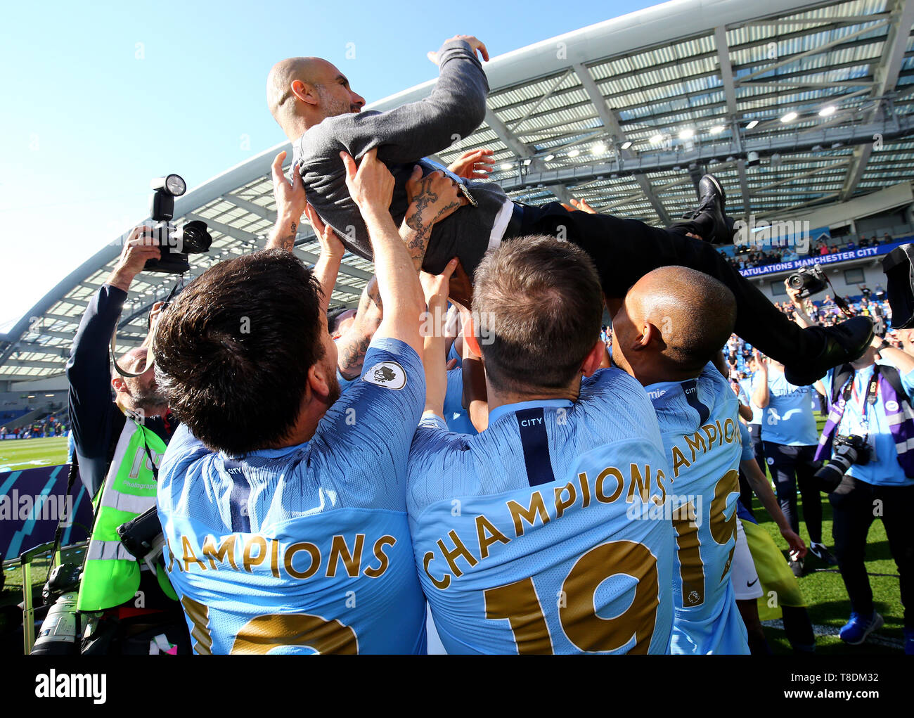 Manchester City manager Pep Guardiola is lifted up by his players ...