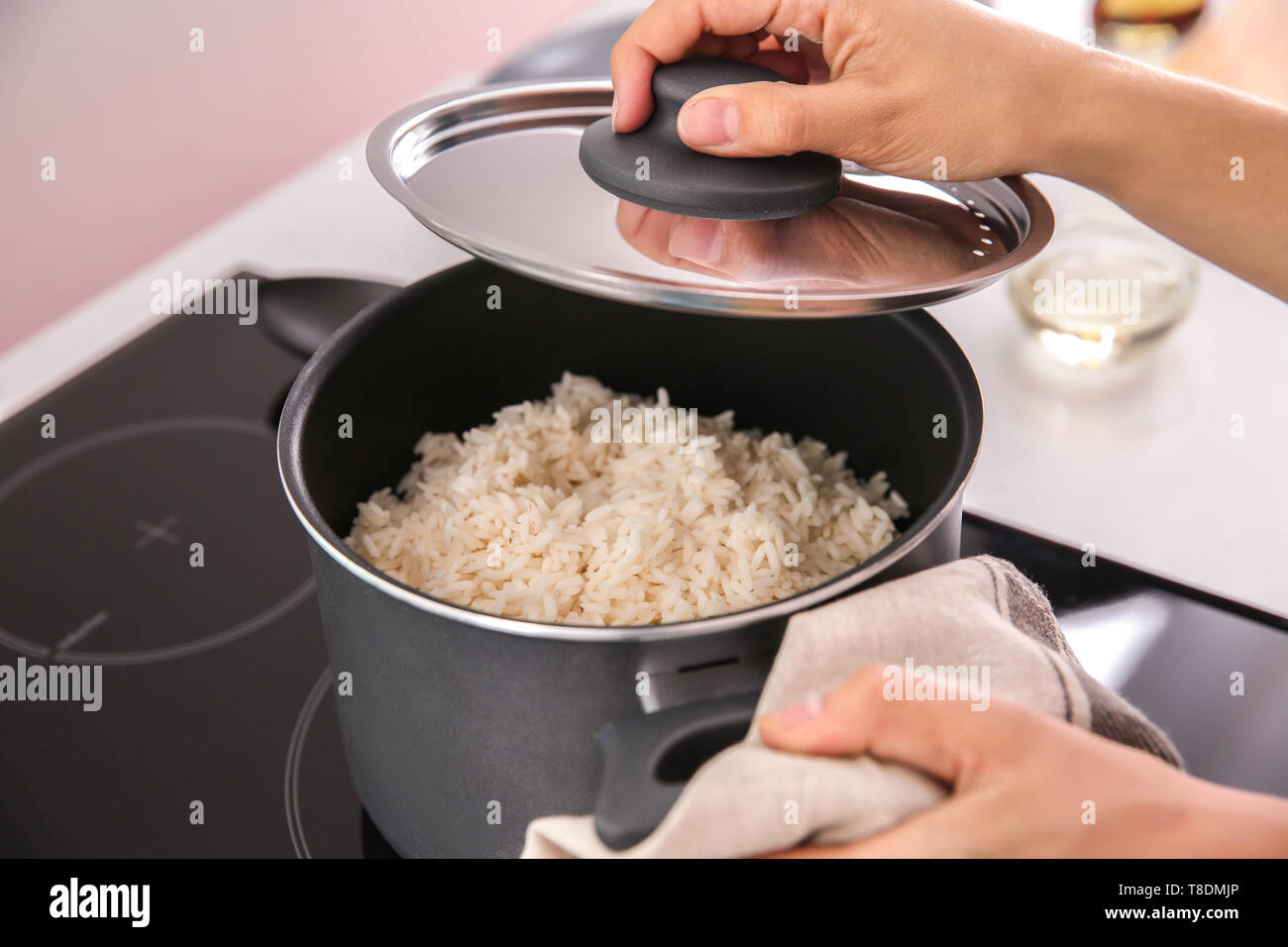 Woman cooking rice in kitchen Stock Photo - Alamy