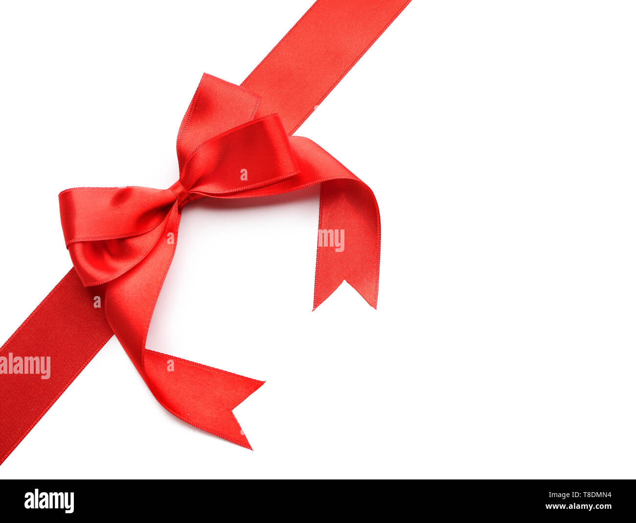 Red ribbon with bow on white background Stock Photo - Alamy