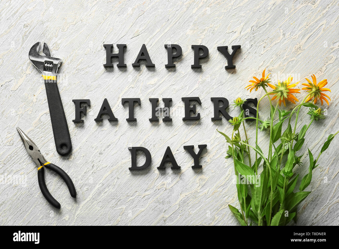 Phrase "Happy Father's Day", tools and flowers on table Stock Photo - Alamy