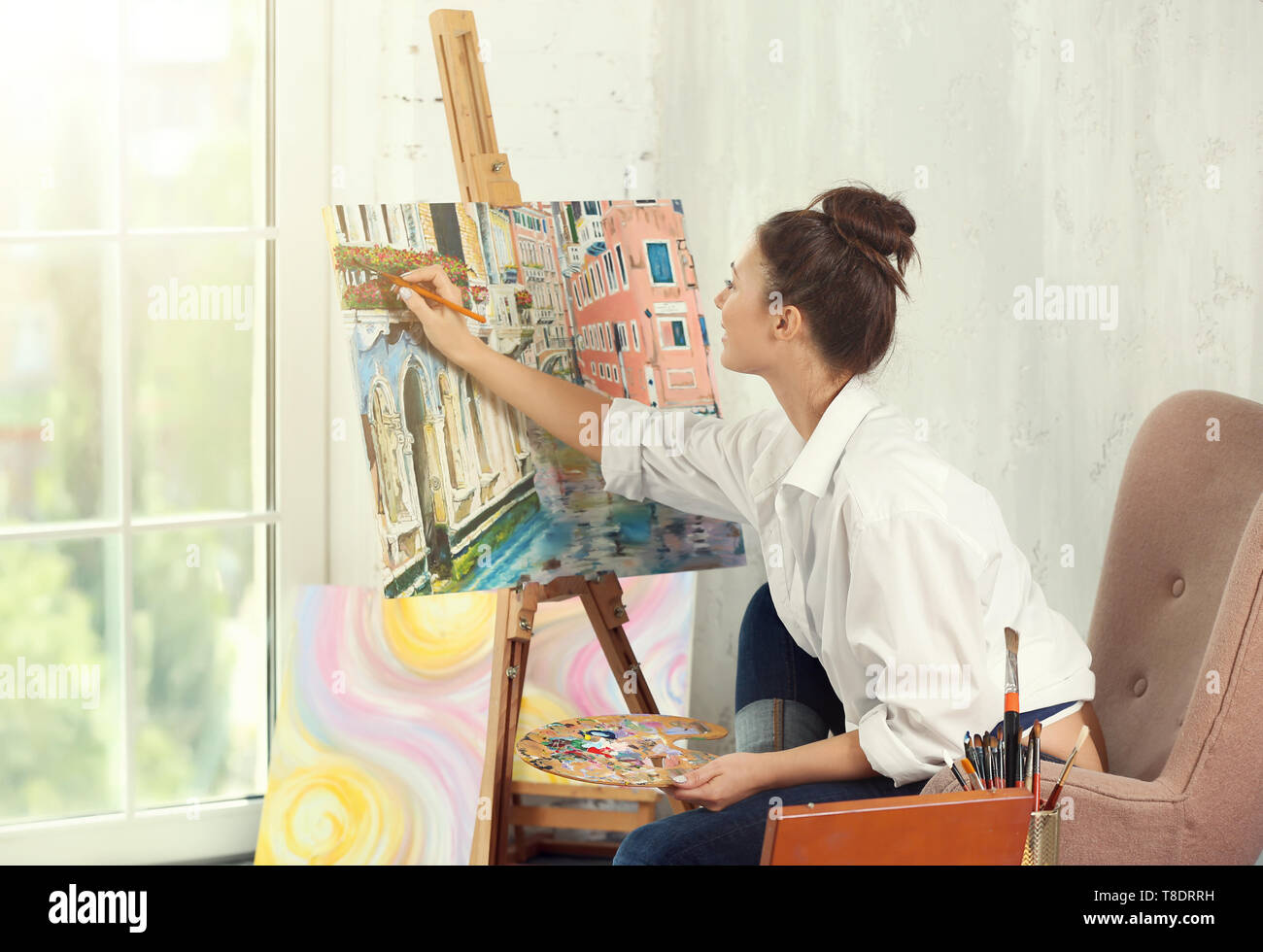 Artist female paints masterpiece sitting hi-res stock photography and ...