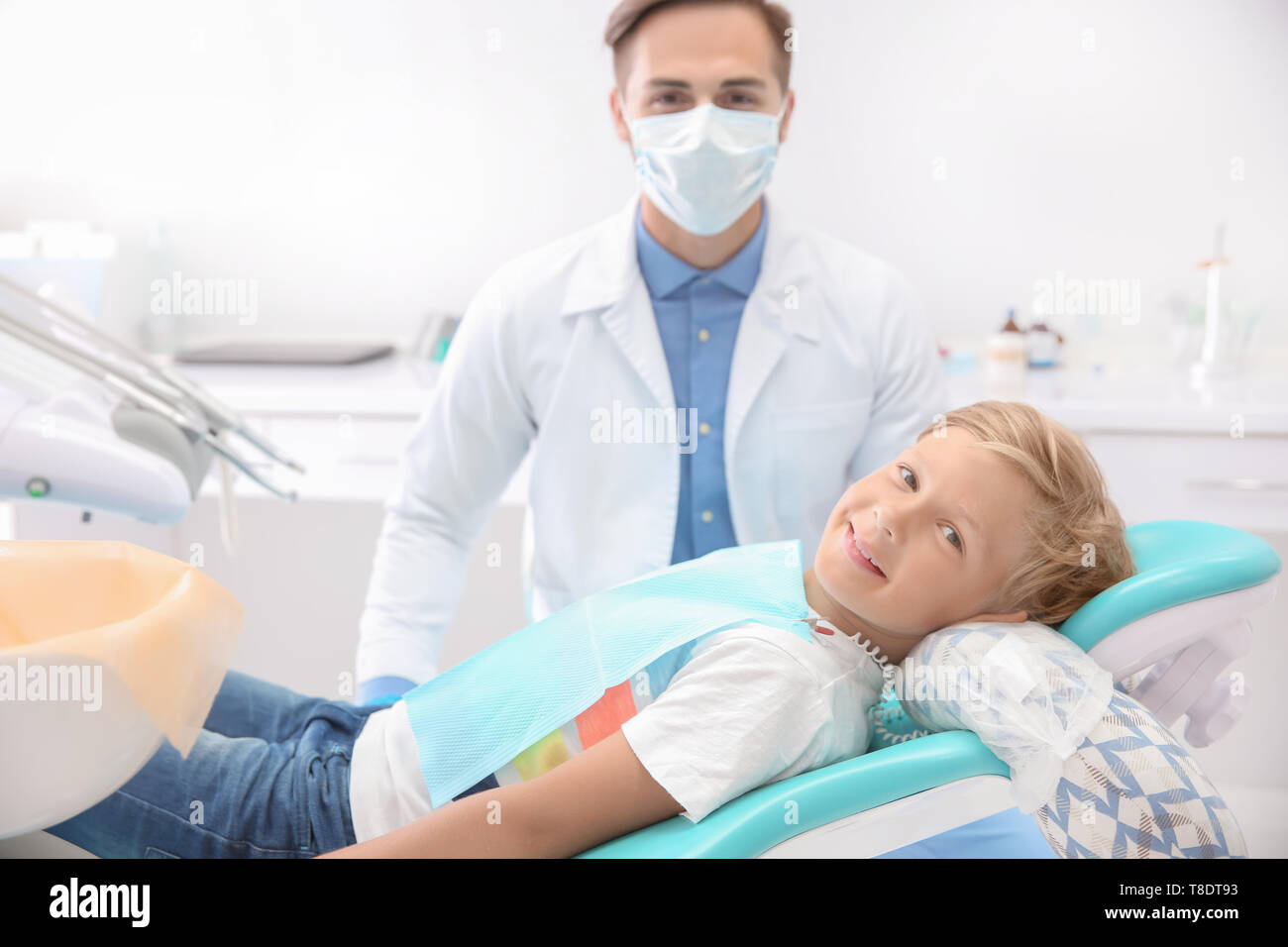 Dentist examining little boy's teeth in clinic Stock Photo - Alamy