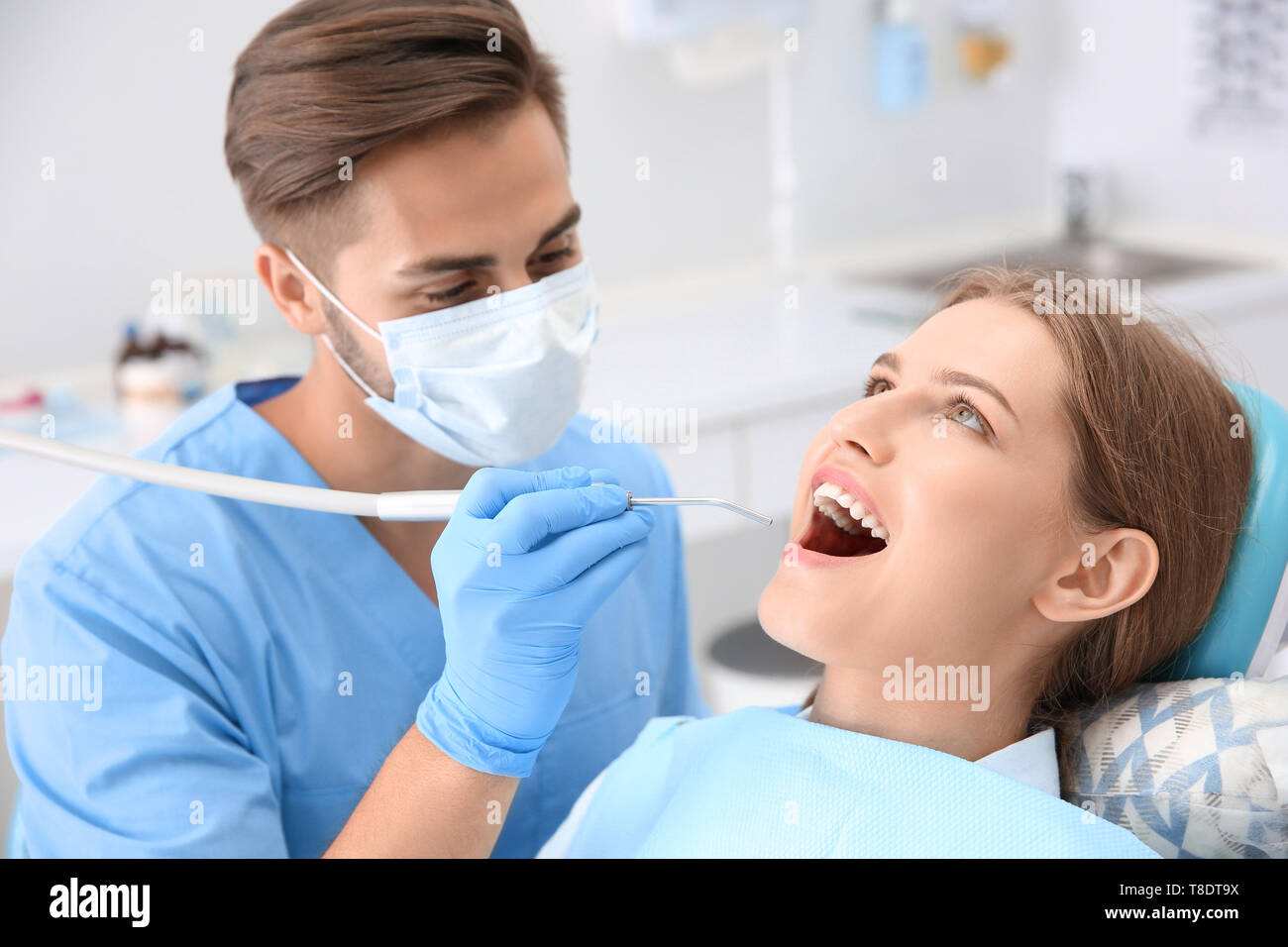 Dentist examining patient's teeth in clinic Stock Photo - Alamy