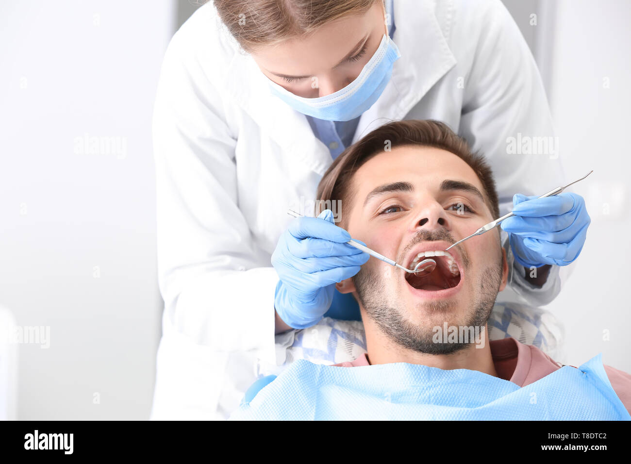 Dentist examining patient's teeth in clinic Stock Photo - Alamy