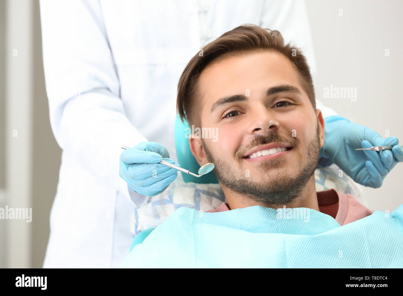 Dentist examining patient's teeth in clinic Stock Photo - Alamy