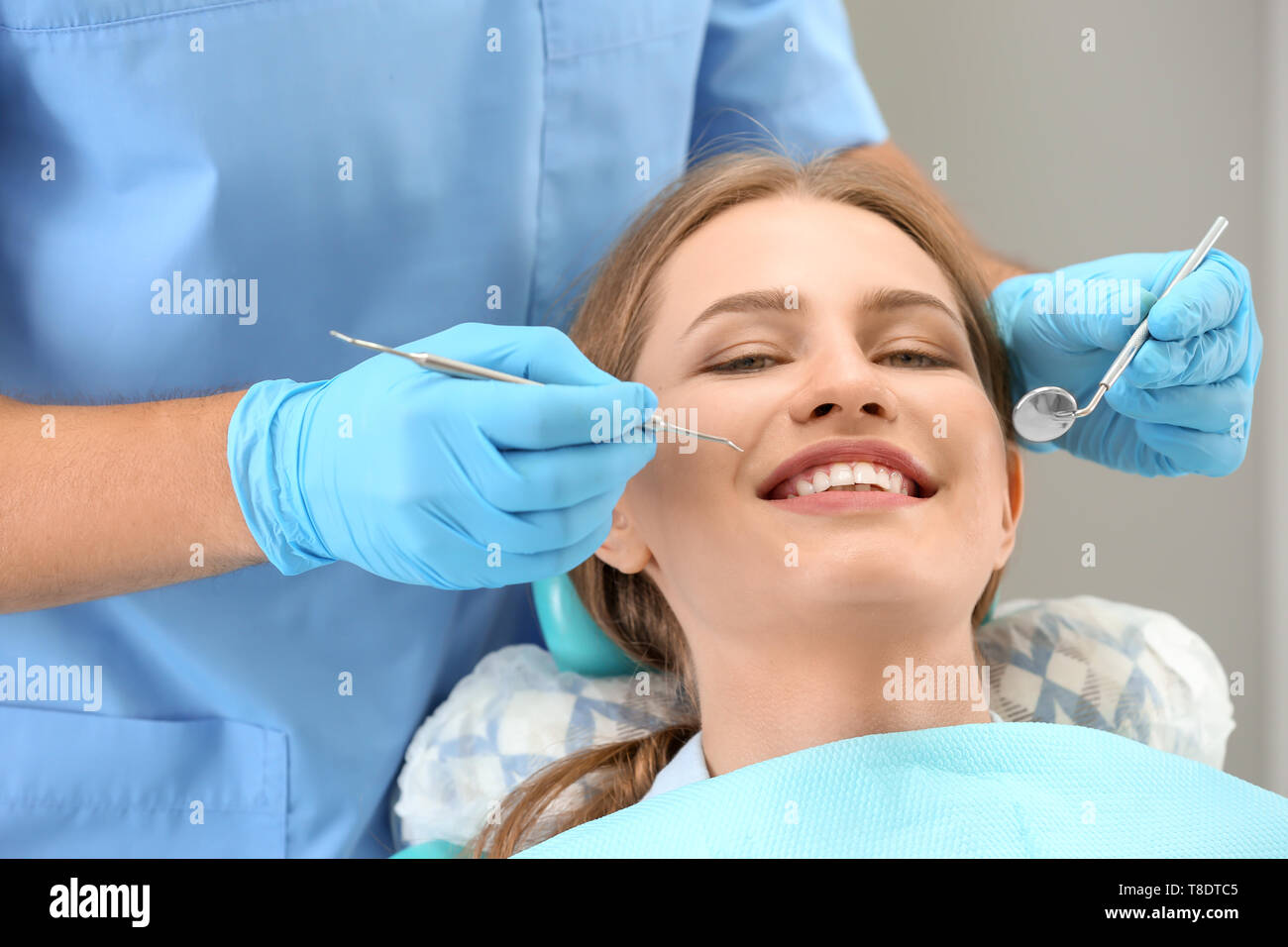Dentist examining patient's teeth in clinic Stock Photo - Alamy