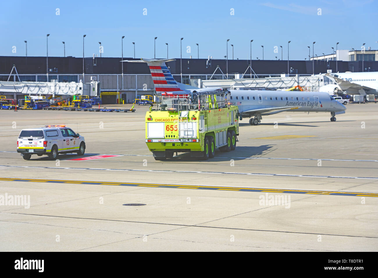 CHICAGO, IL -21 APR 2019- View of a yellow firetruck near an American ...