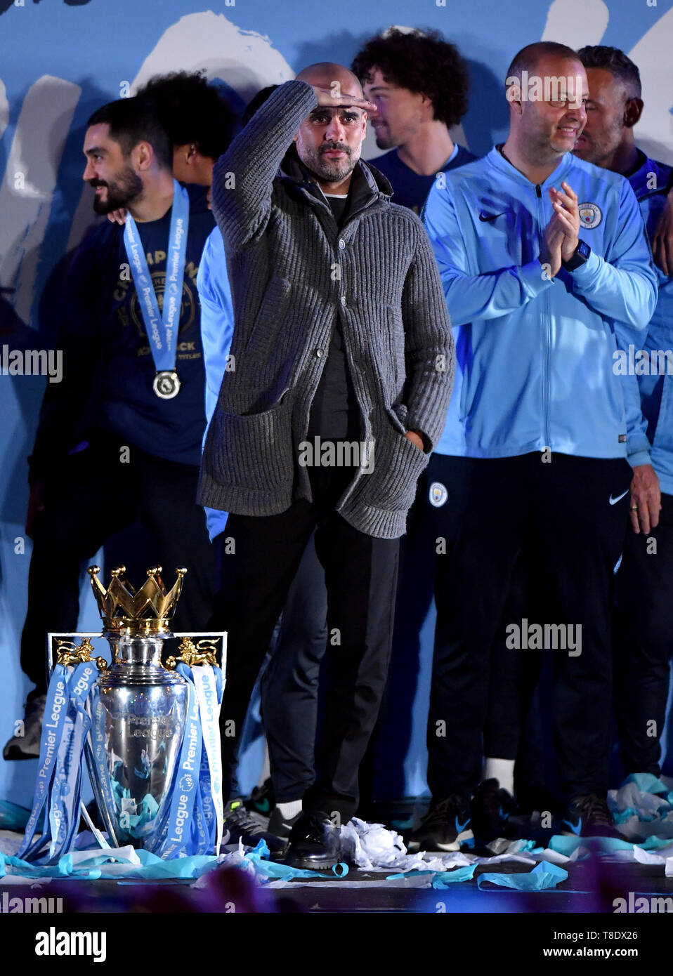 Manchester City manager Pep Guardiola with the trophy on stage during ...