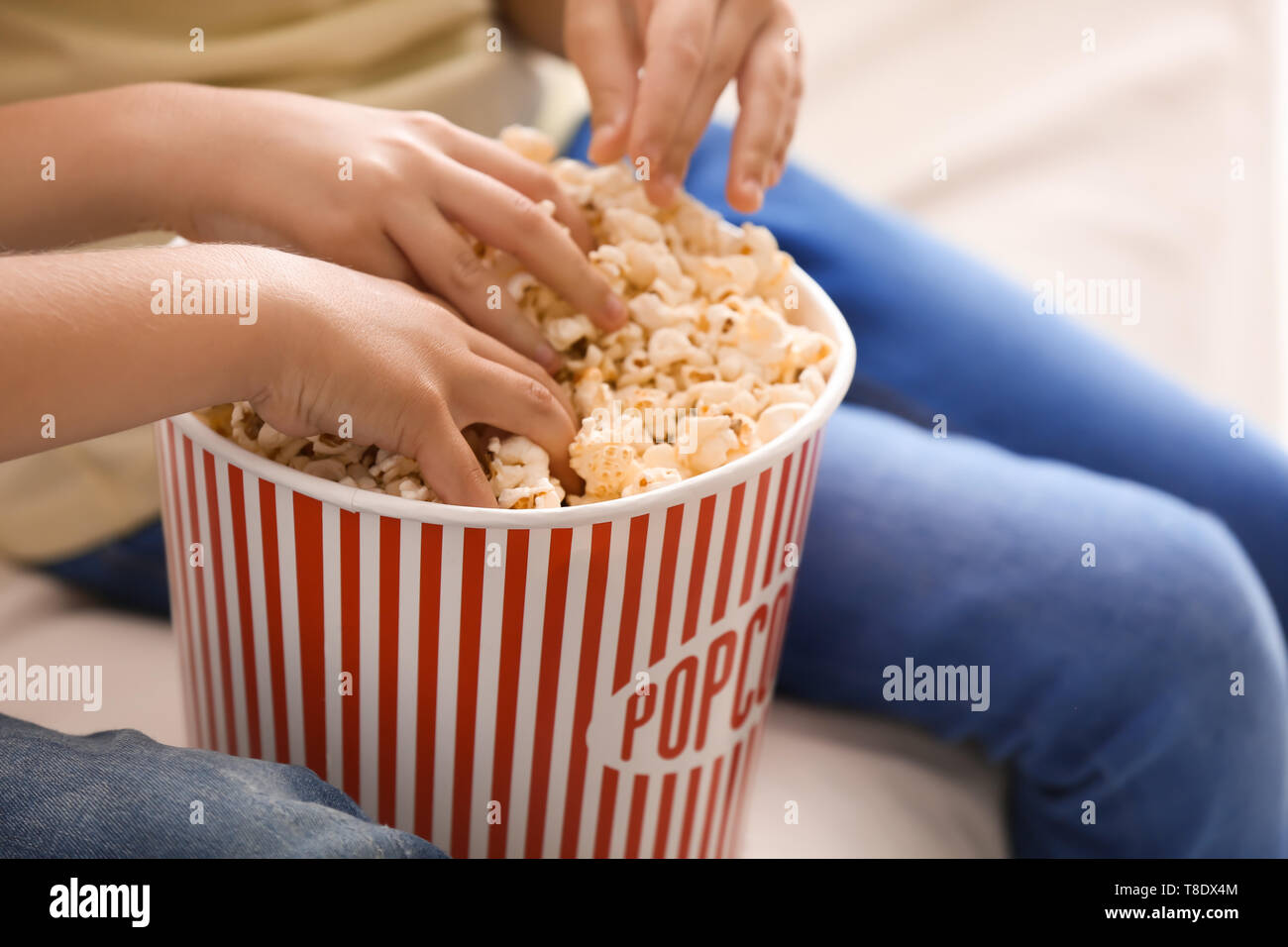 Children eating popcorn at home, closeup Stock Photo - Alamy
