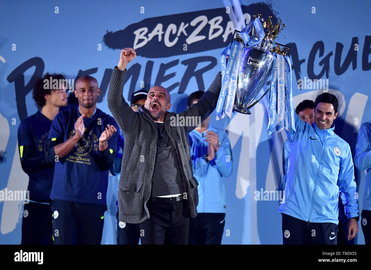 Manchester City manager Pep Guardiola with the trophy on stage during ...