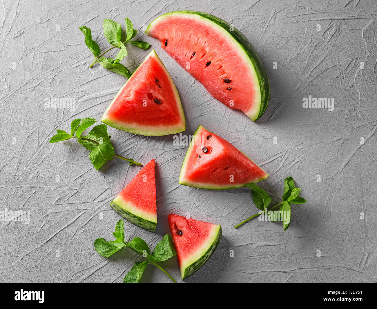 Sweet watermelon slices on grey textured background Stock Photo - Alamy