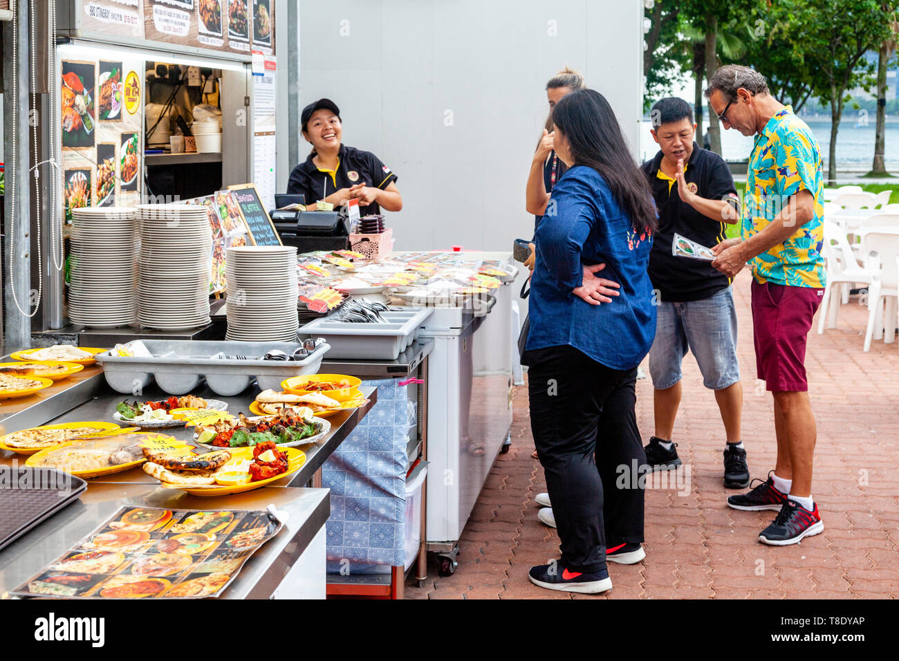 Tourists At An Outside Food Court Near Raffles Avenue, Singapore, South ...