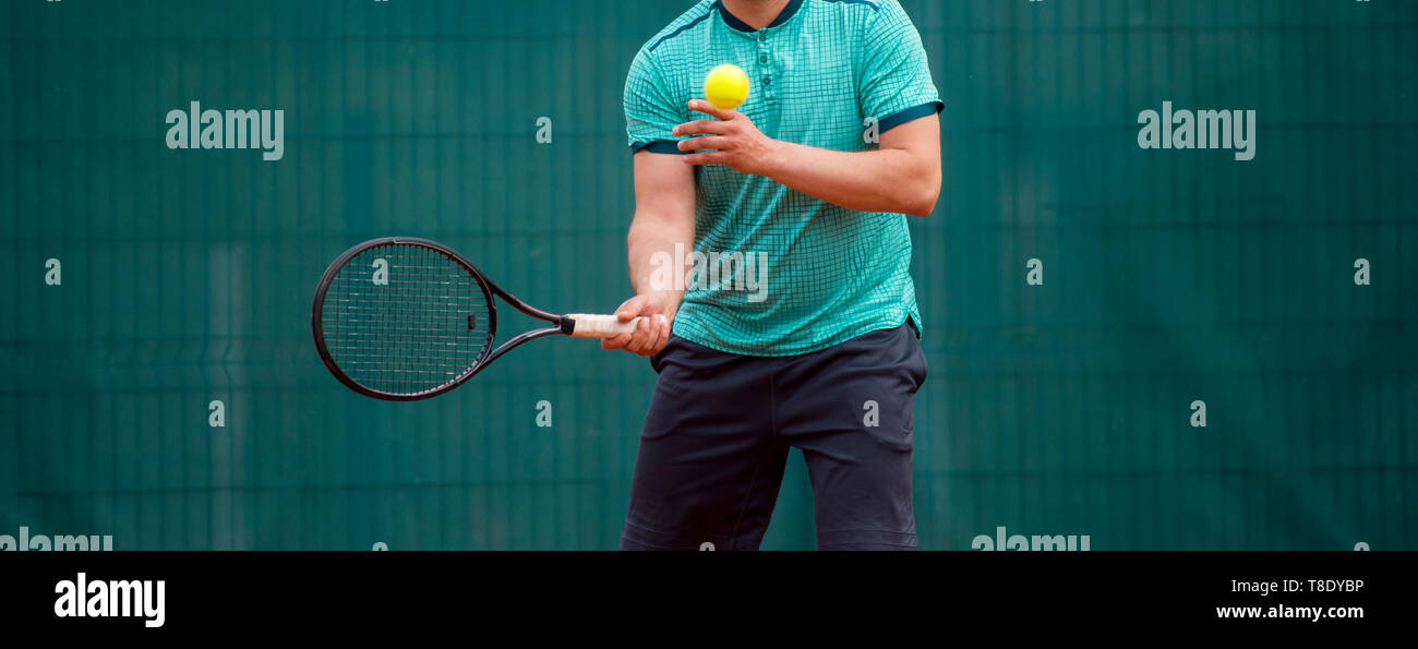 Male tennis player in action. Racket sport Stock Photo - Alamy