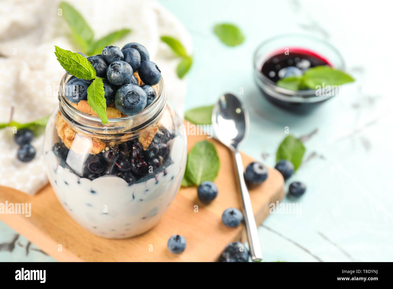 Glass jar with delicious blueberry dessert on board Stock Photo - Alamy