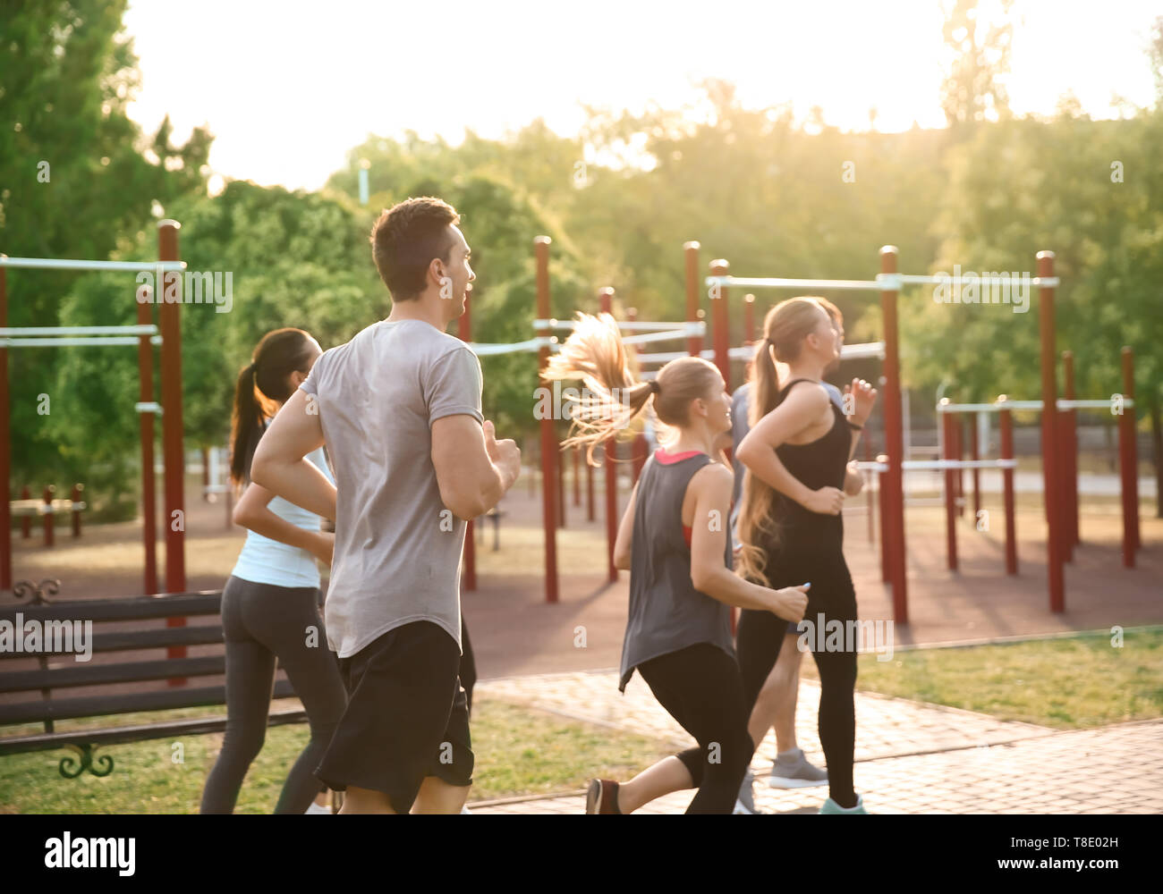Group of sporty people running outdoors Stock Photo - Alamy