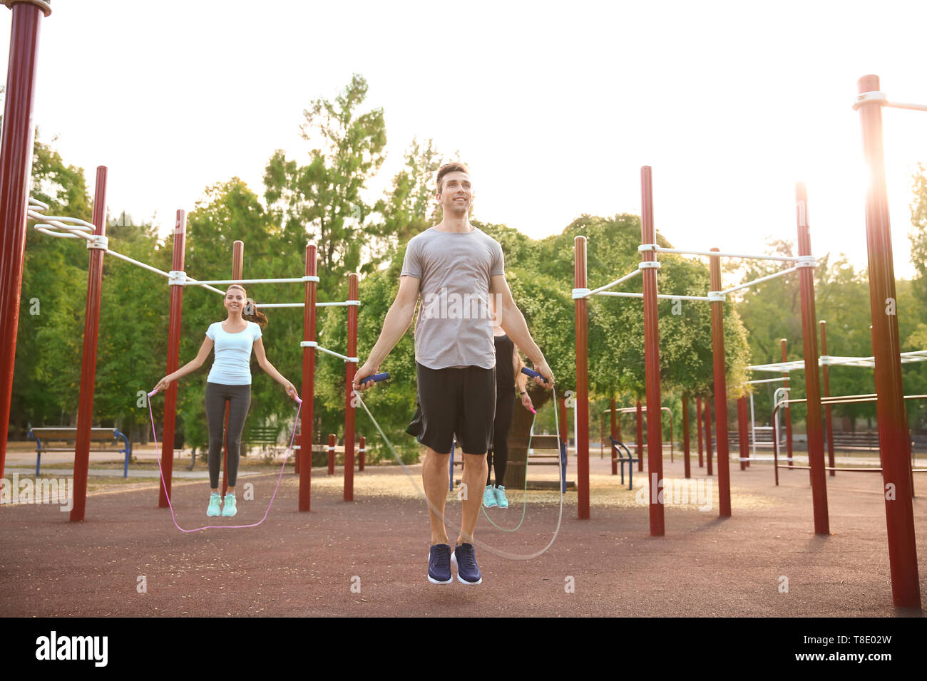 Group of sporty people jumping rope on athletic field outdoors Stock ...