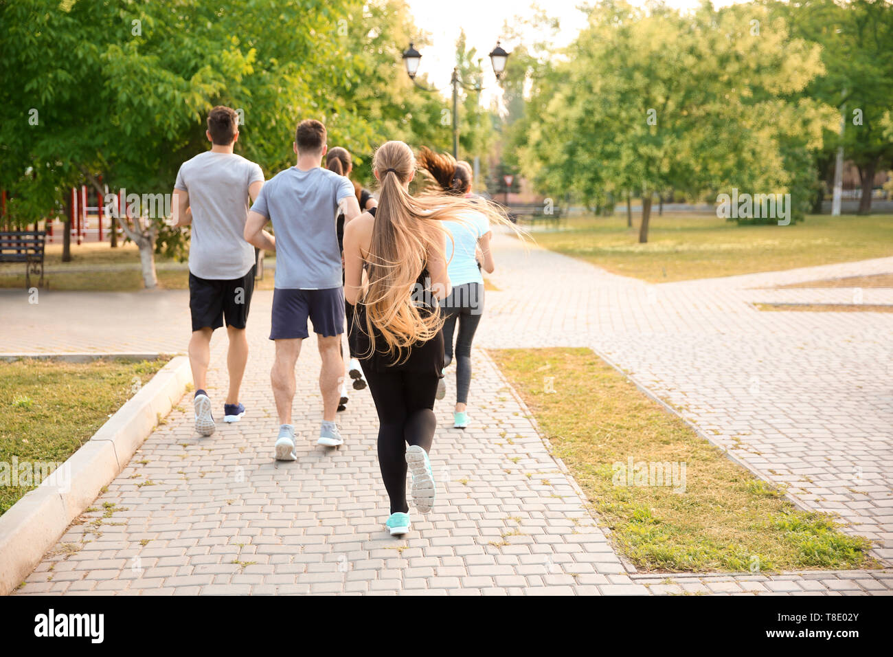 Group of sporty people running outdoors Stock Photo - Alamy