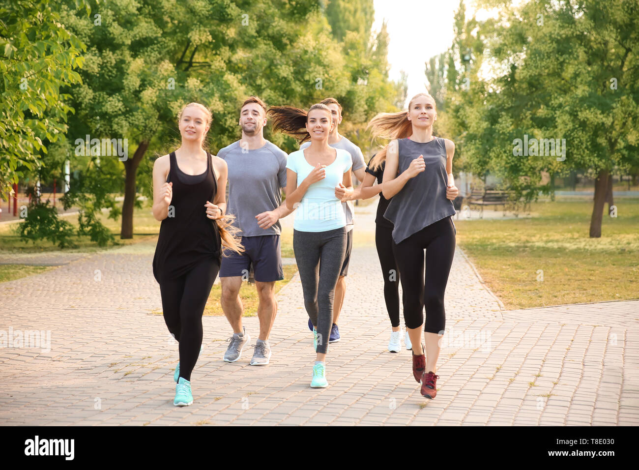 Group of sporty people running outdoors Stock Photo - Alamy