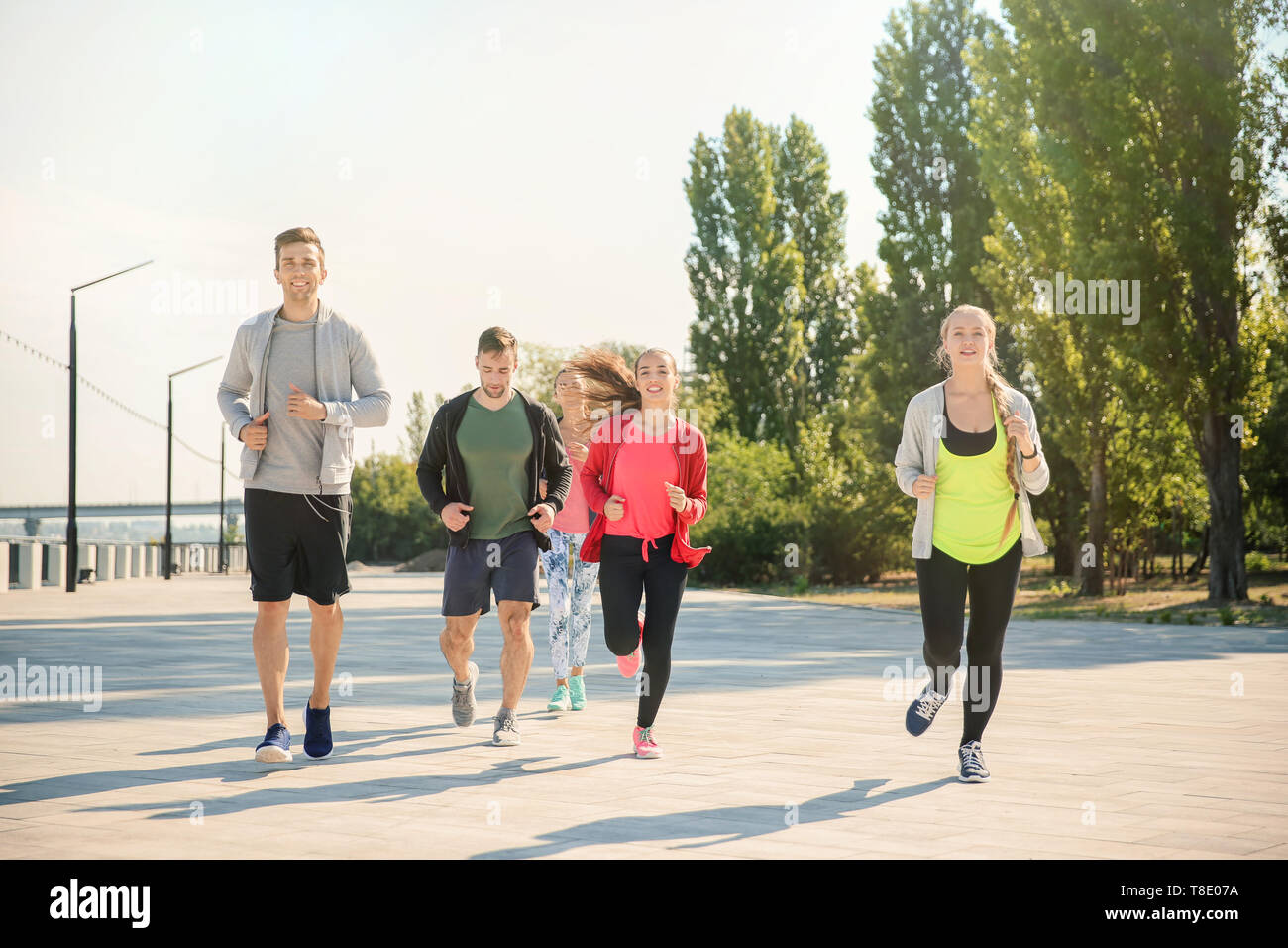 Group of sporty people running outdoors Stock Photo - Alamy
