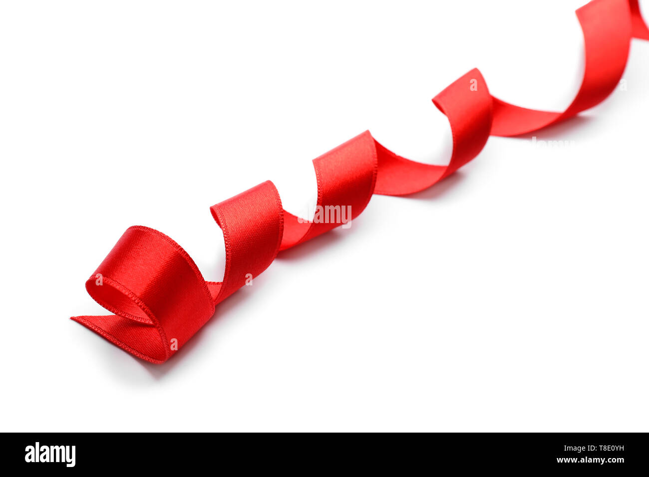Curled red ribbon on white background Stock Photo - Alamy