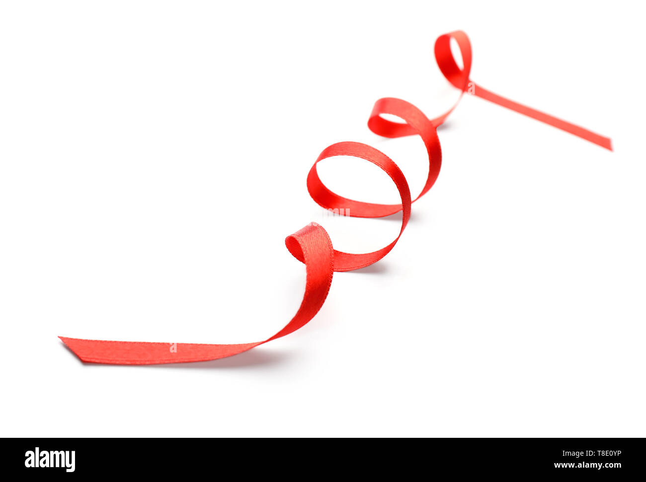 Curled red ribbon on white background Stock Photo - Alamy