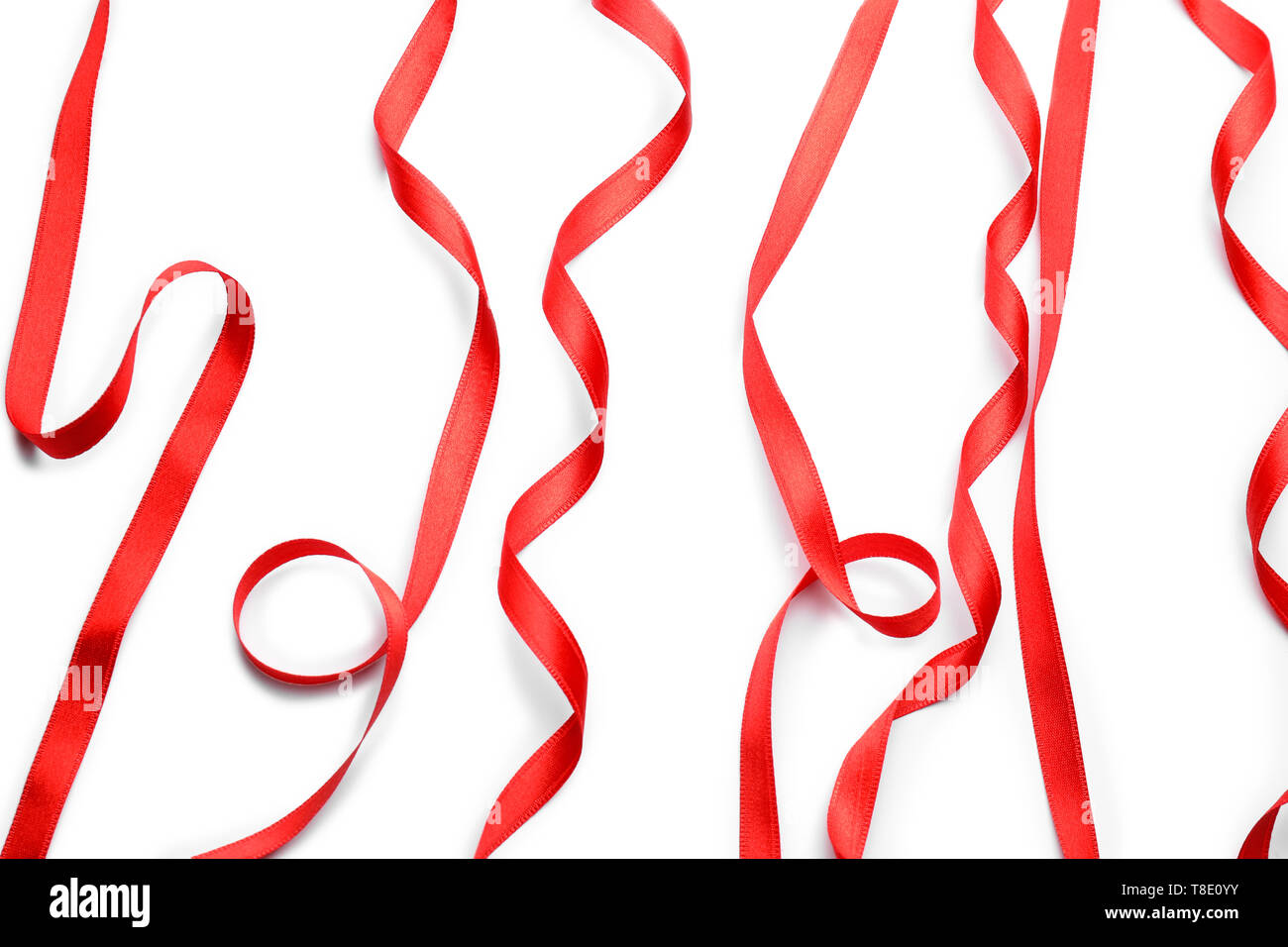 Curled red ribbons on white background Stock Photo - Alamy