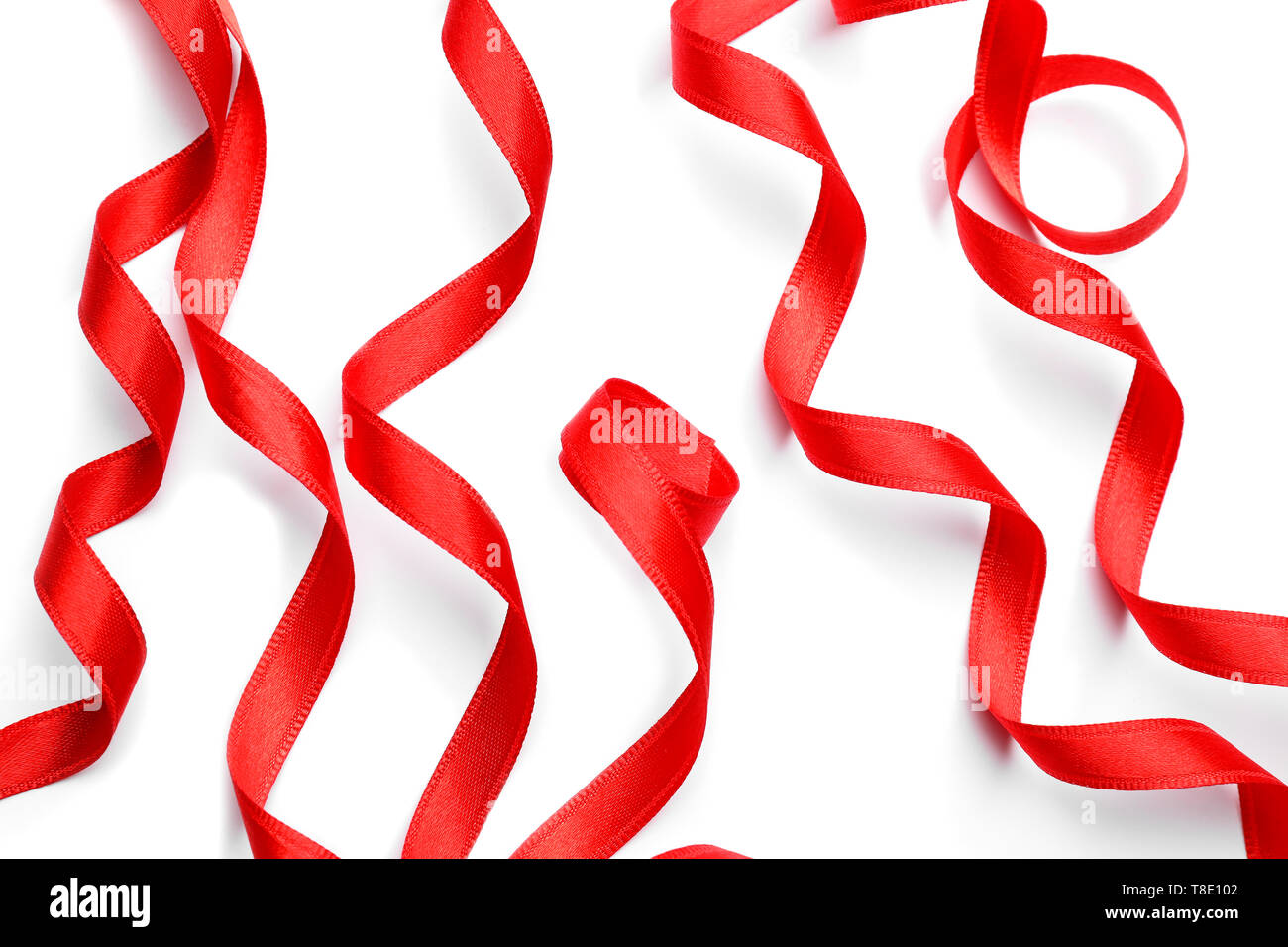 Curled red ribbons on white background Stock Photo - Alamy