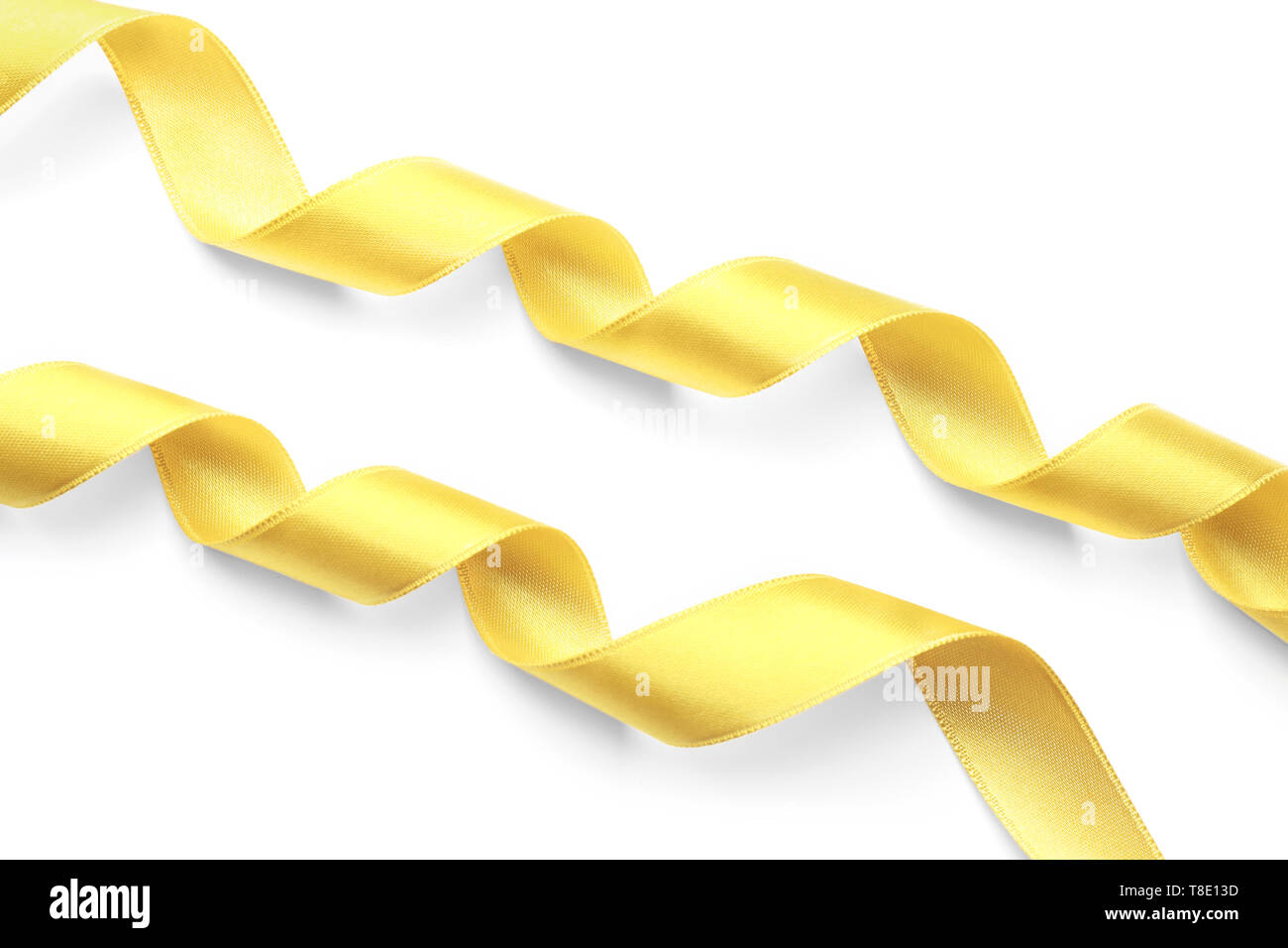 Yellow satin ribbons on white background Stock Photo - Alamy