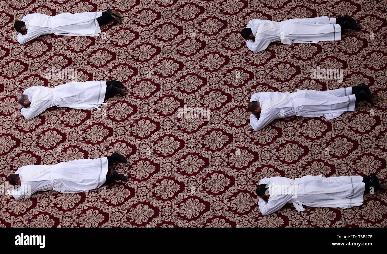 Holy See, Vatican. 12th May, 2019. Priests lay face down on the floor ...